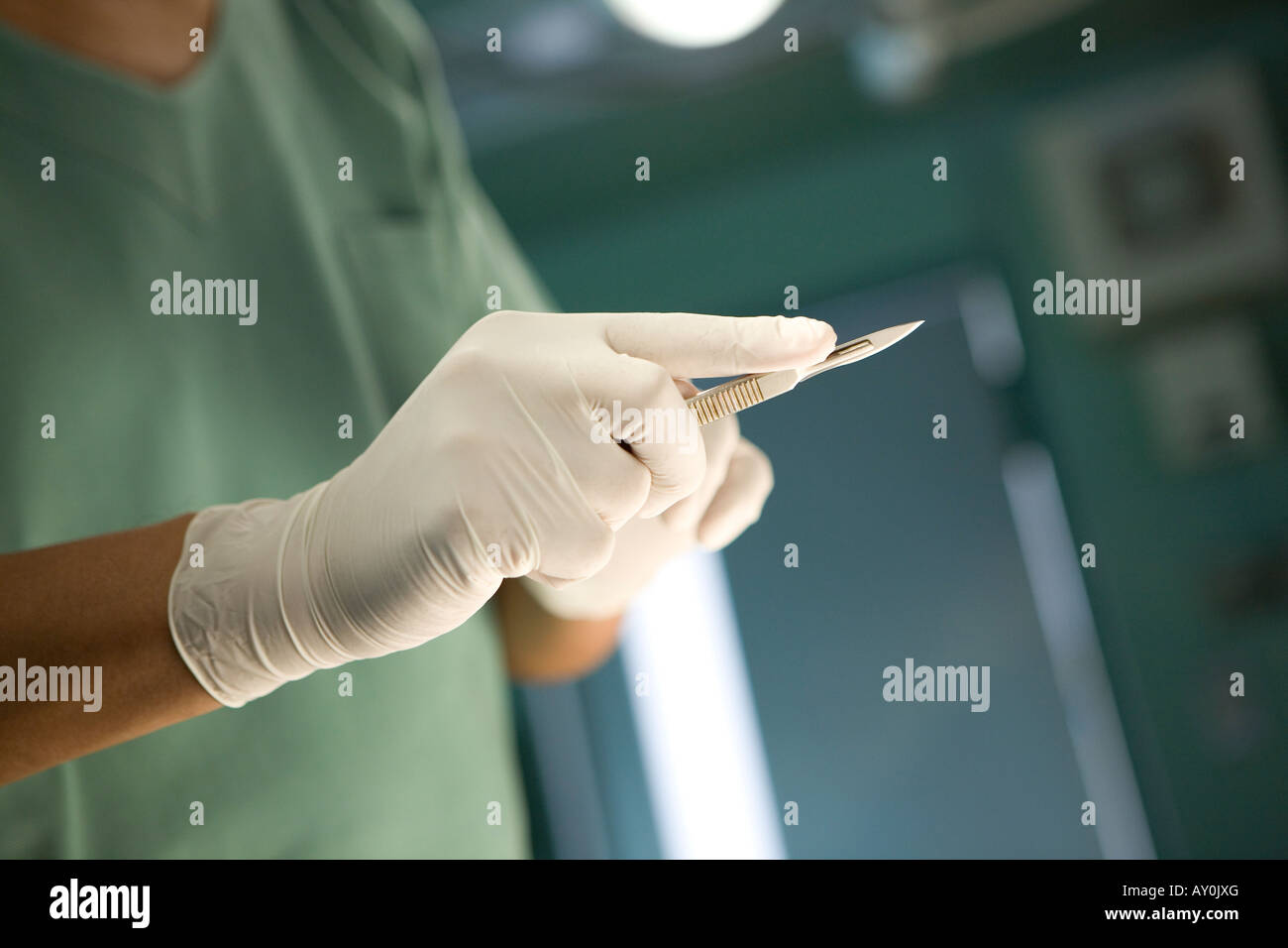 Doctor holding scalpel Stock Photo - Alamy
