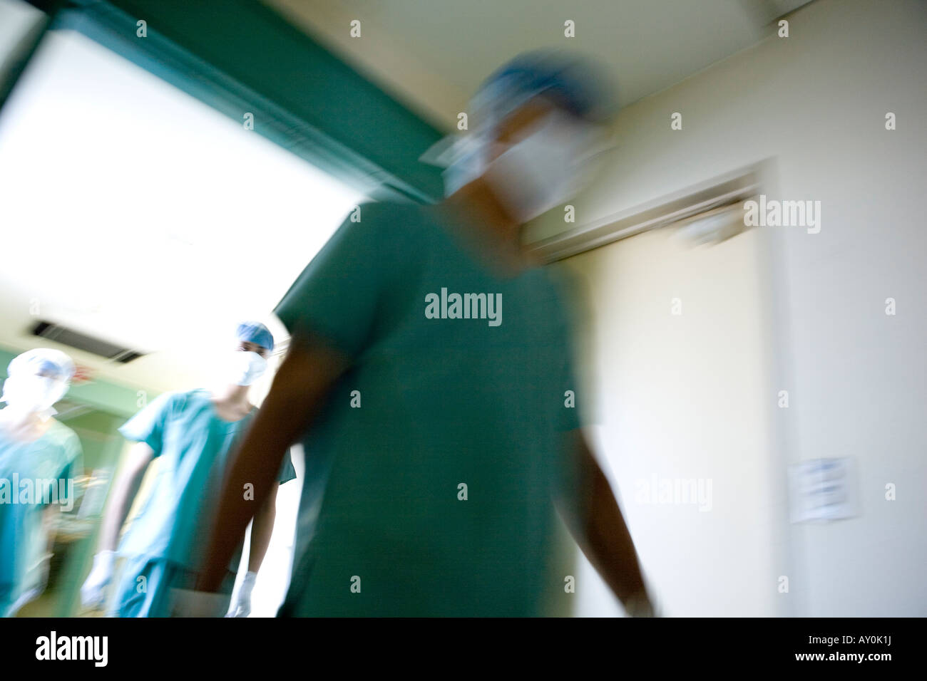 Doctors and nurse walking out of surgery Stock Photo - Alamy