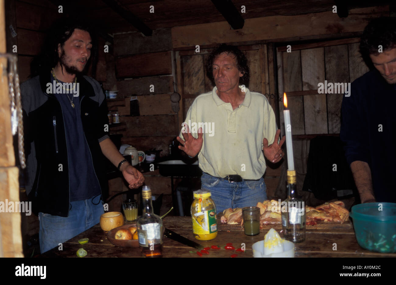 Three men preparing supper Stock Photo - Alamy