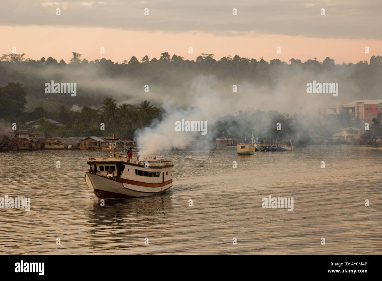 Small boat emitting smoke pollution, Manokwari, West Papua, Indonesia ...