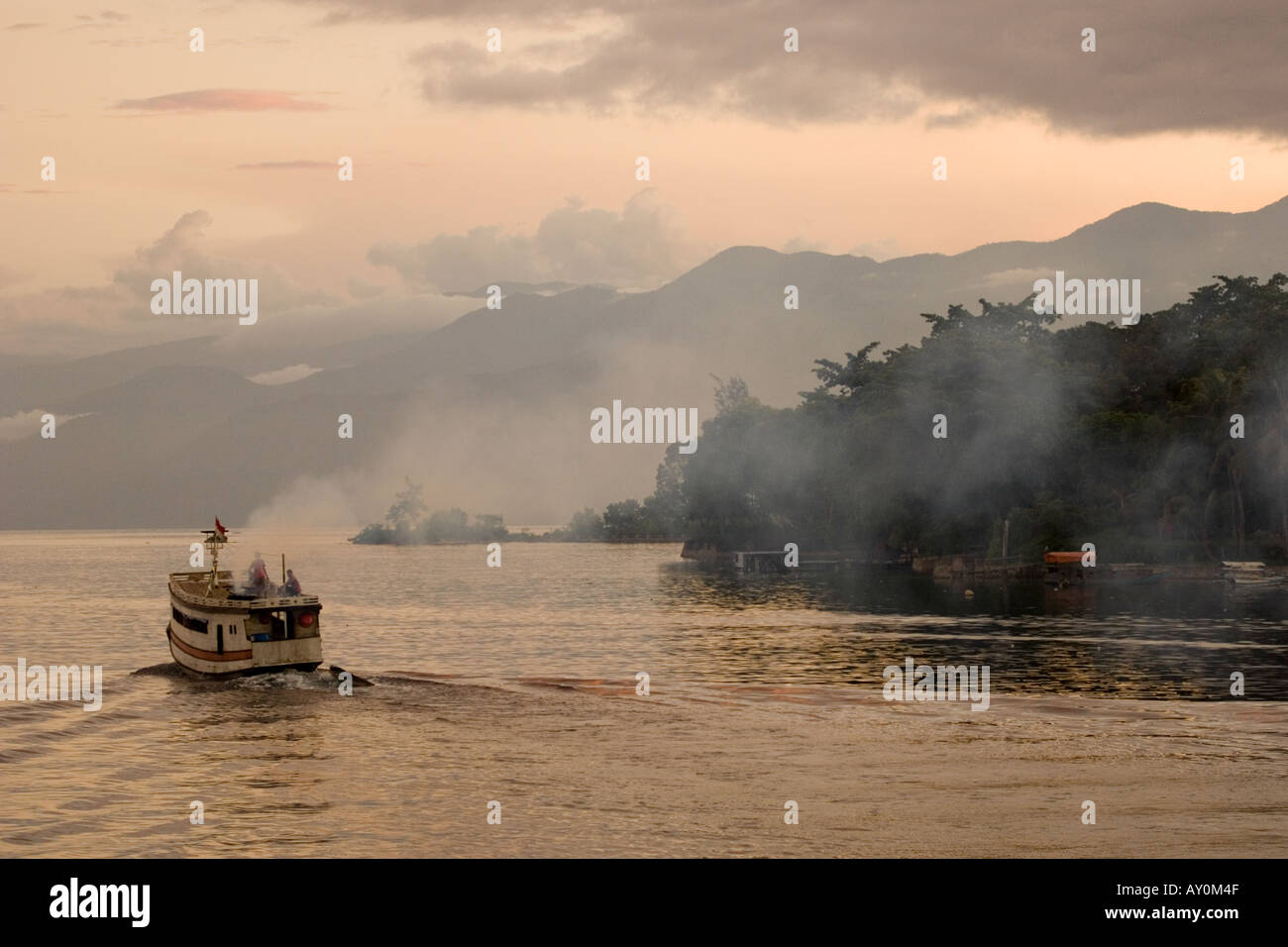 Small boat emitting smoke pollution, Manokwari, West Papua, Indonesia ...