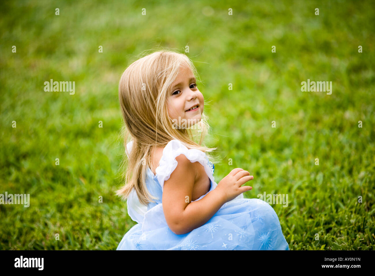 Side view of a smiling girl looking over shoulder Stock Photo - Alamy