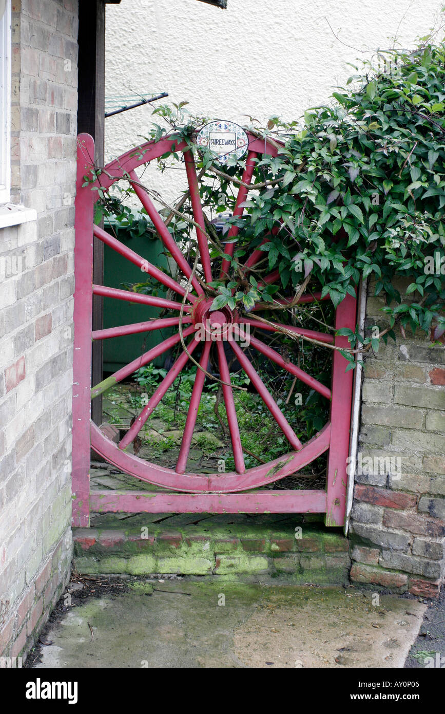 Wagon wheel reused as an unusual garden gate Stock Photo - Alamy
