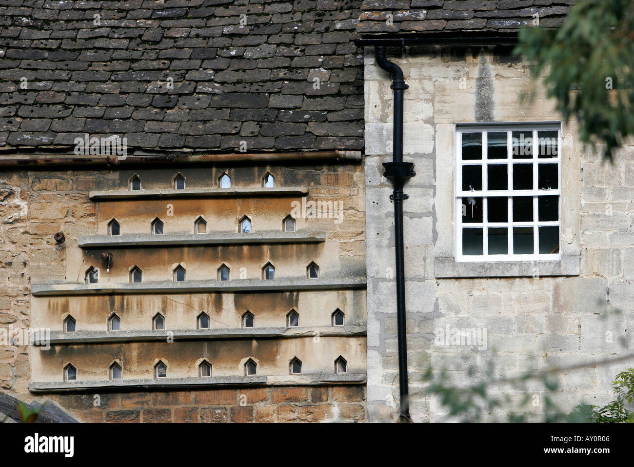 Dovecote in back wall of farmhouse Stock Photo - Alamy
