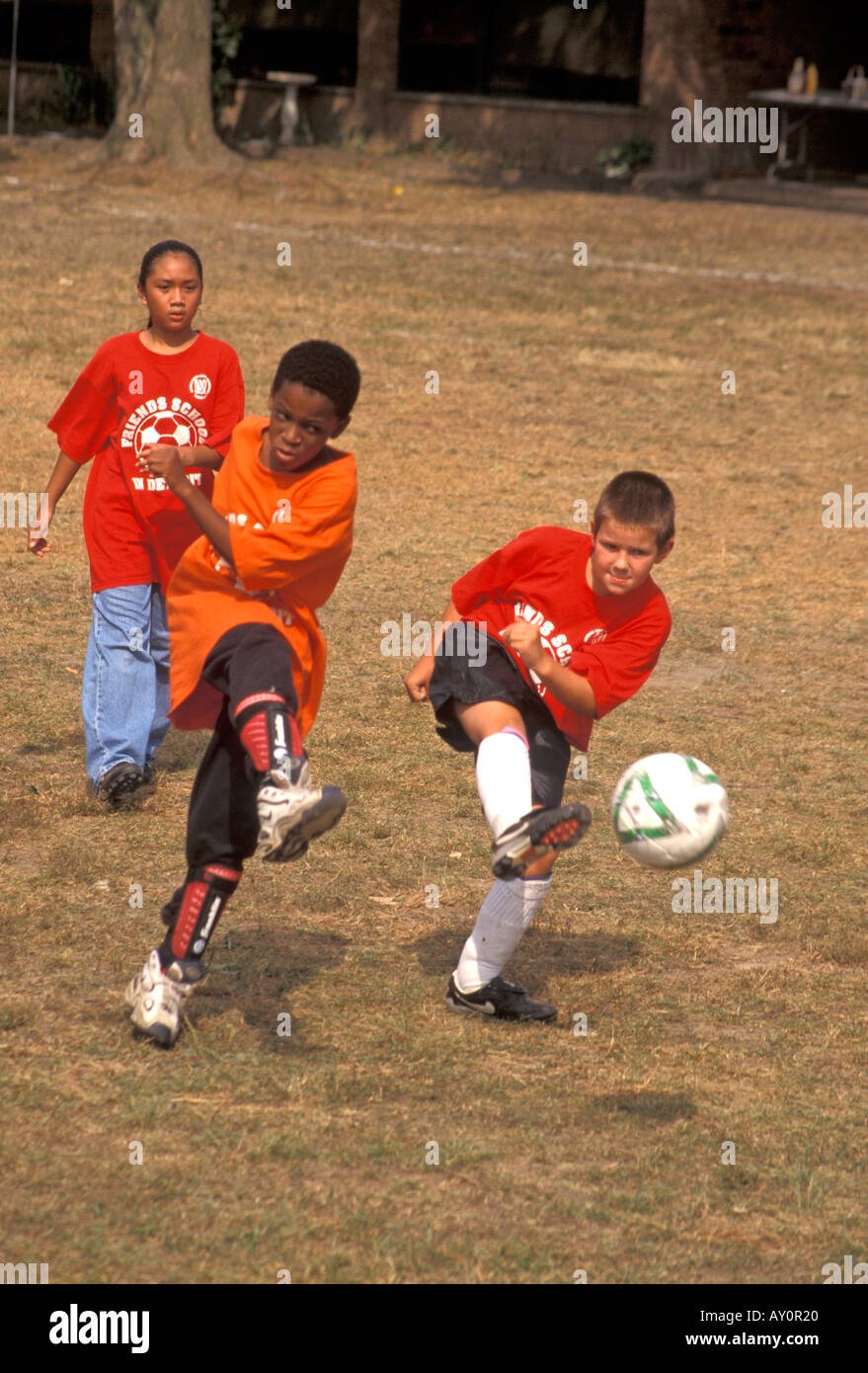 Diverse children playing football hi-res stock photography and images ...