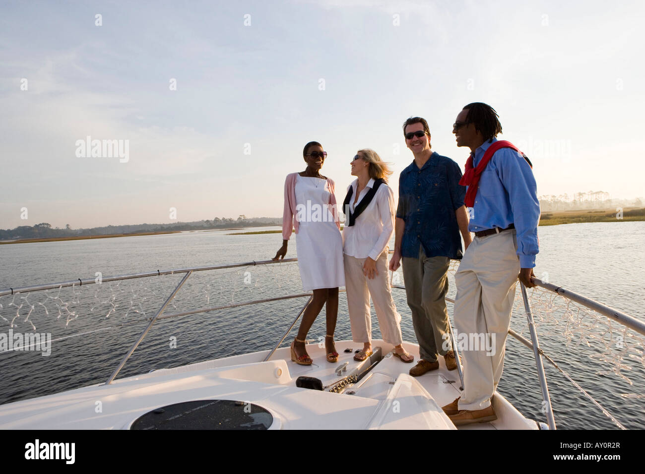 Portrait of smiling friends at bow of a boat Stock Photo - Alamy