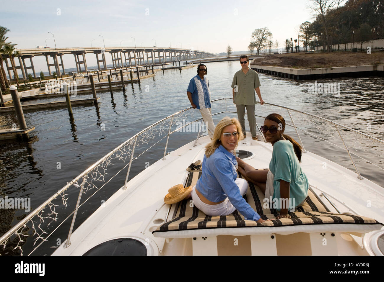 Portrait of smiling friends relaxing on the deck of a boat Stock Photo ...
