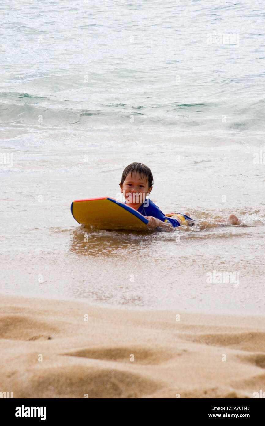 Toddler body boarding Stock Photo - Alamy