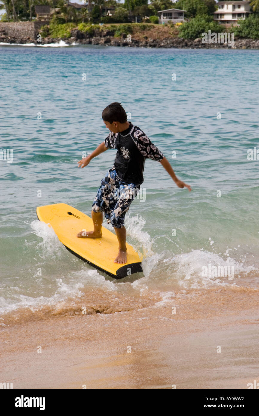 Boy skim boarding, Oahu, Hawaii Stock Photo - Alamy