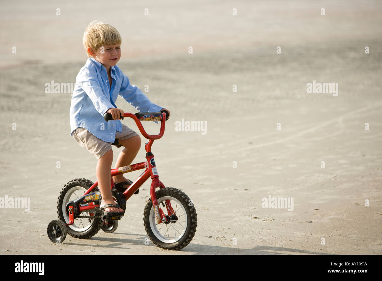 Boy riding cycle at the beach Stock Photo - Alamy
