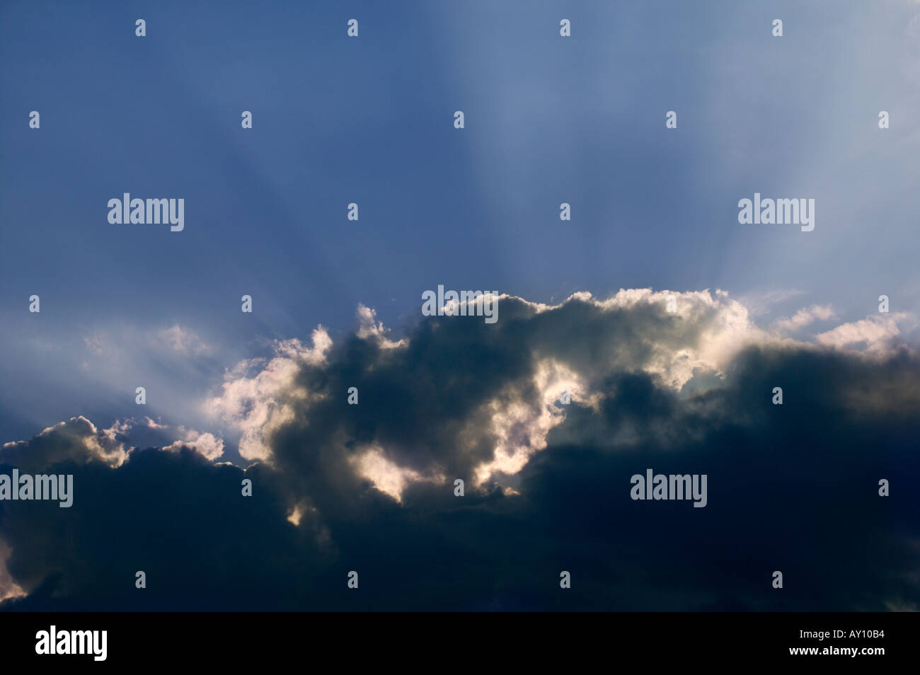 SUNLIGHT SHINING THROUGH CLOUDS CREATING SILVER LINING EFFECT AGAINST ...