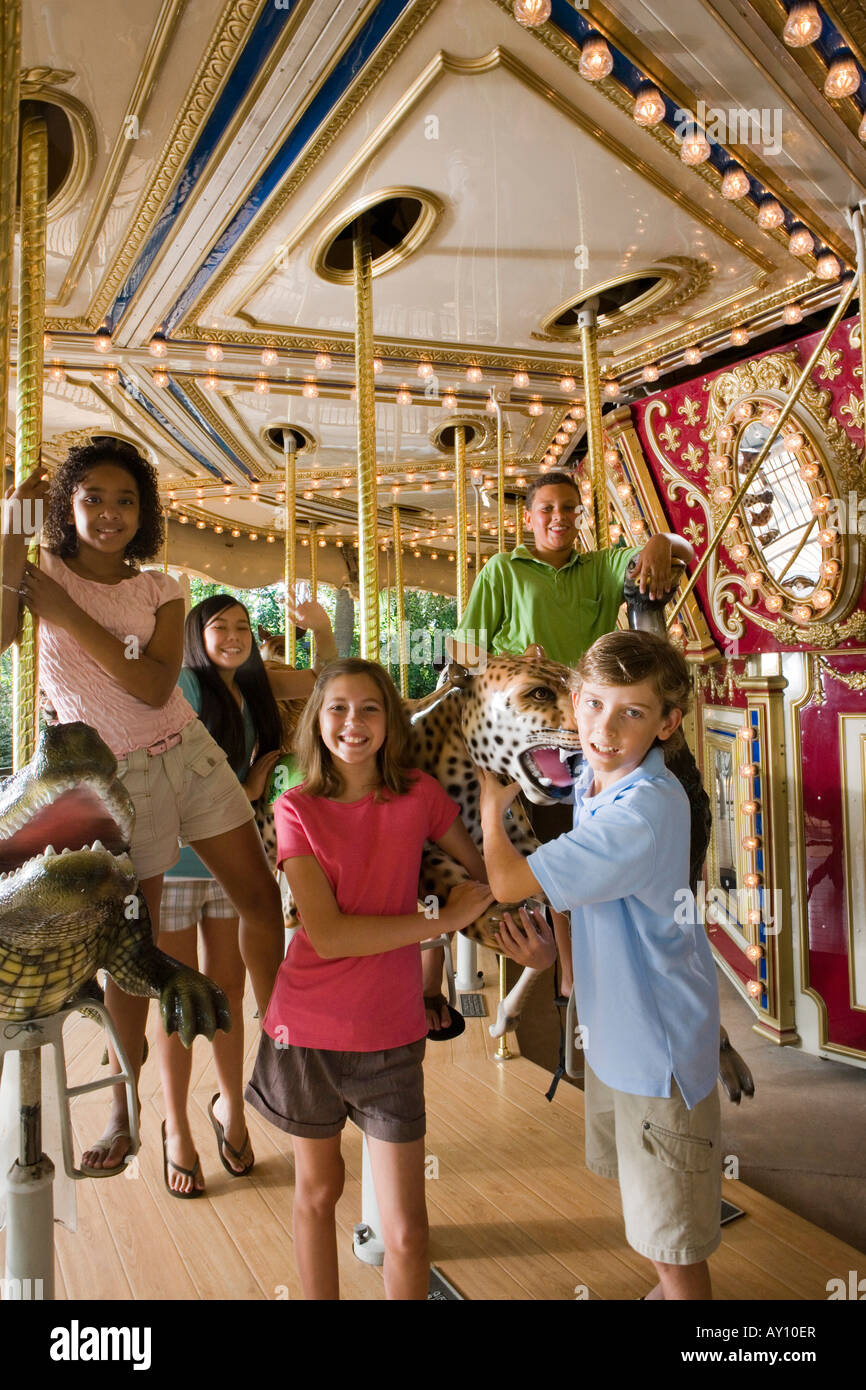 Portrait of cheerful teenagers standing in a carousel Stock Photo - Alamy