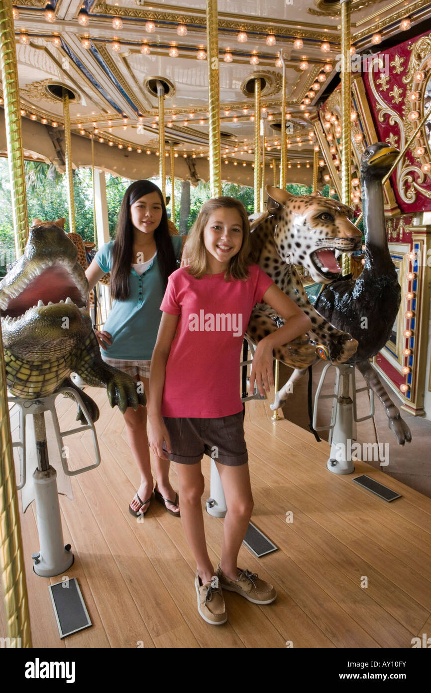 Portrait of cheerful teenage girls standing in a carousel Stock Photo ...