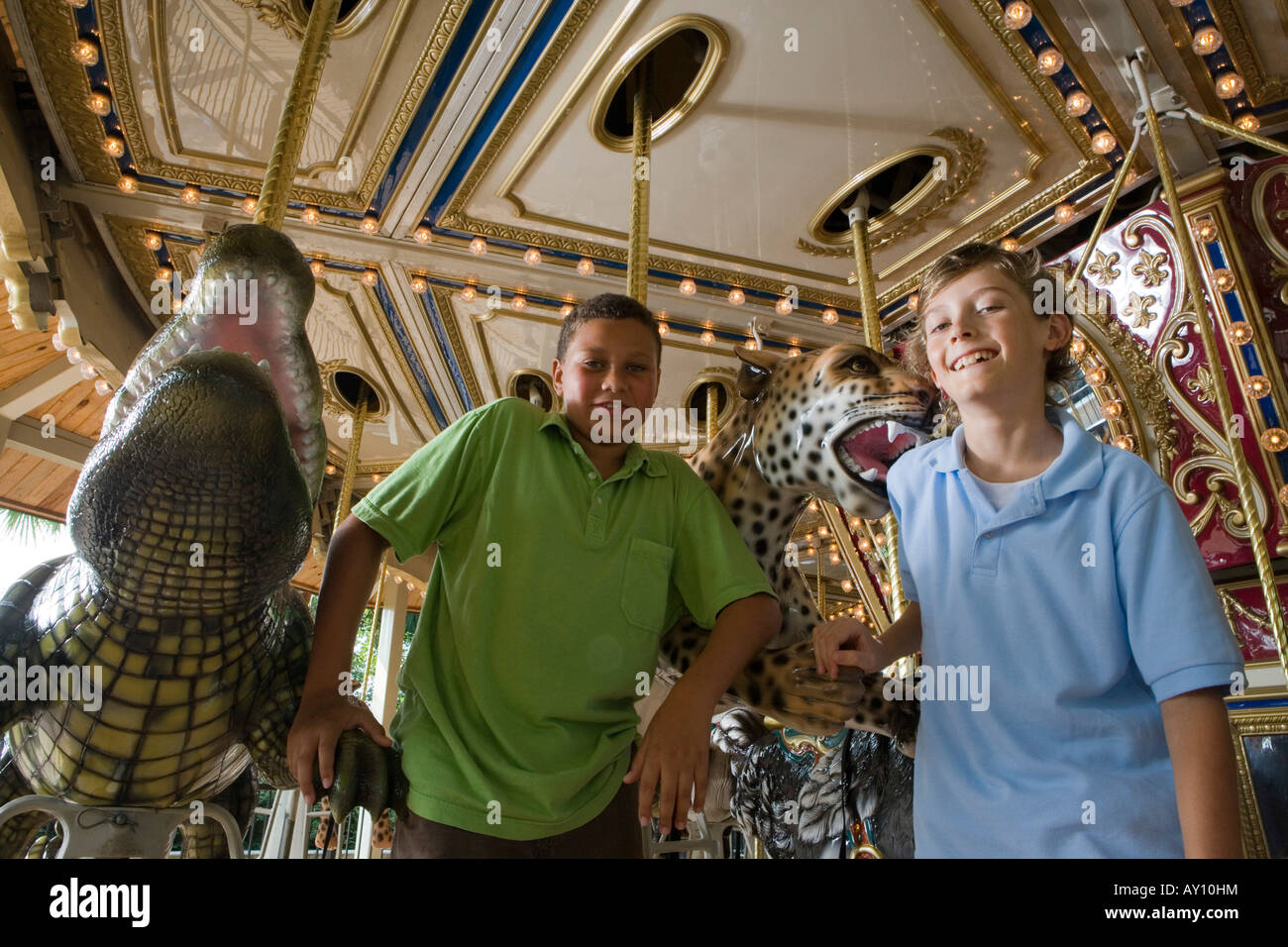 Portrait of teenage boys standing in a carousel by a carousel leopard ...