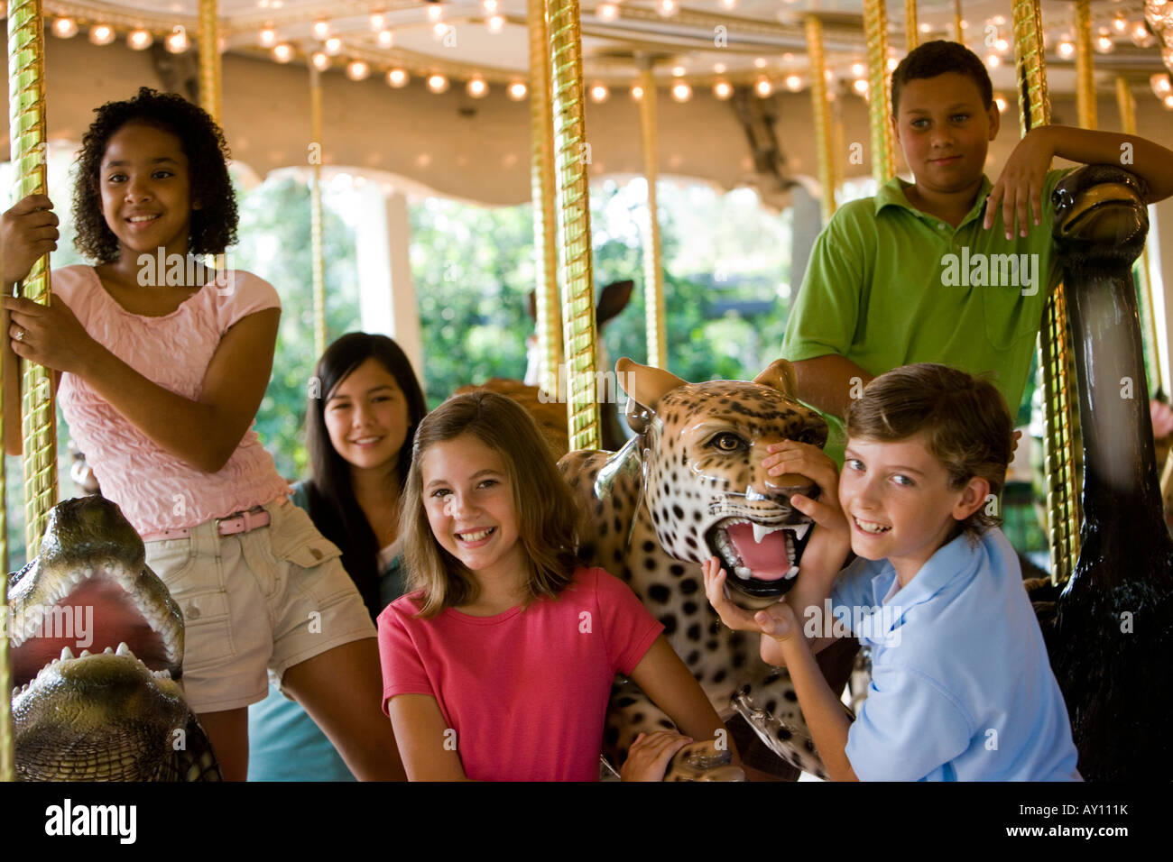 Portrait of cheerful teenagers standing in a carousel Stock Photo - Alamy