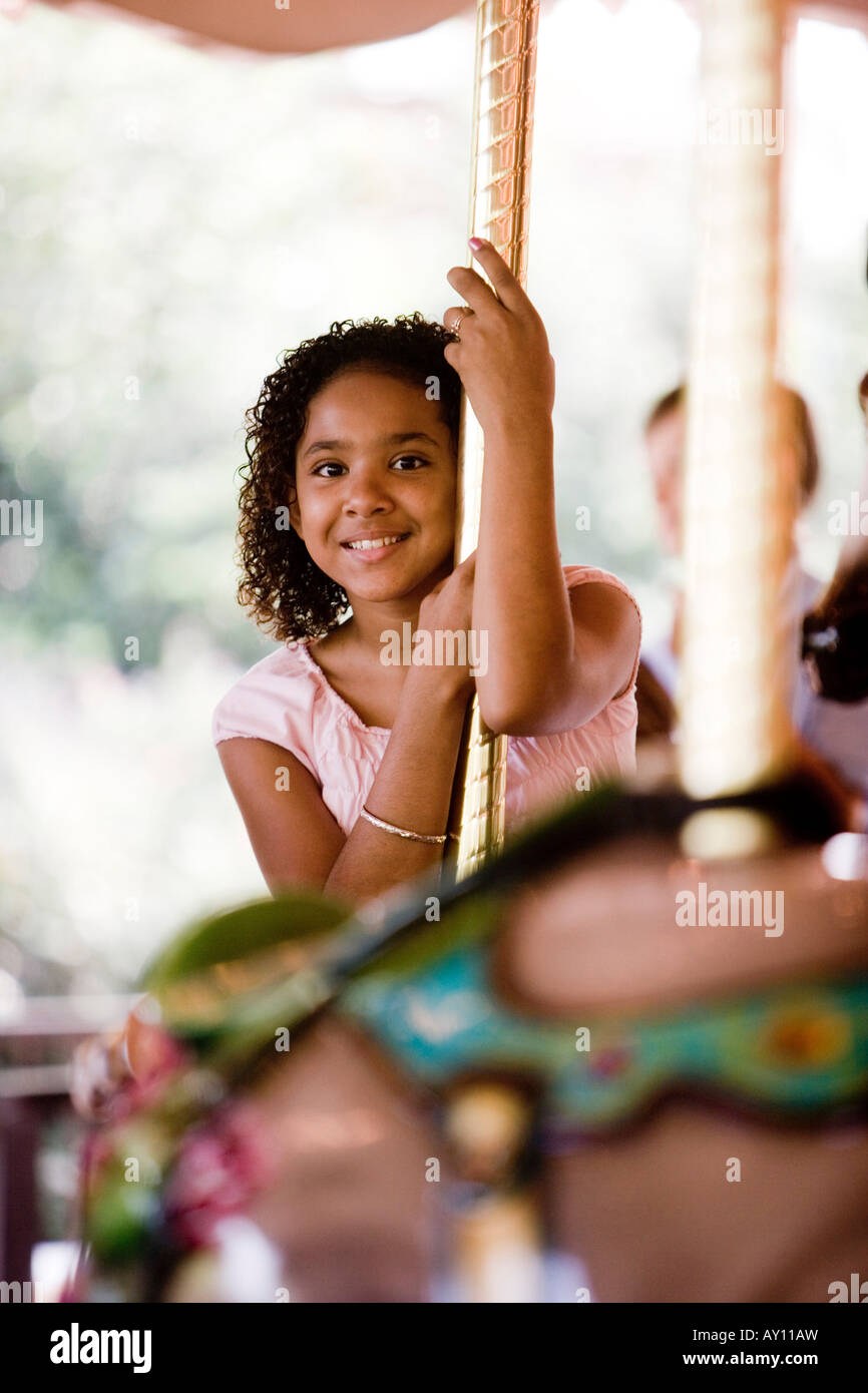 Portrait of a cheerful teenage girl sitting on a carousel Stock Photo ...