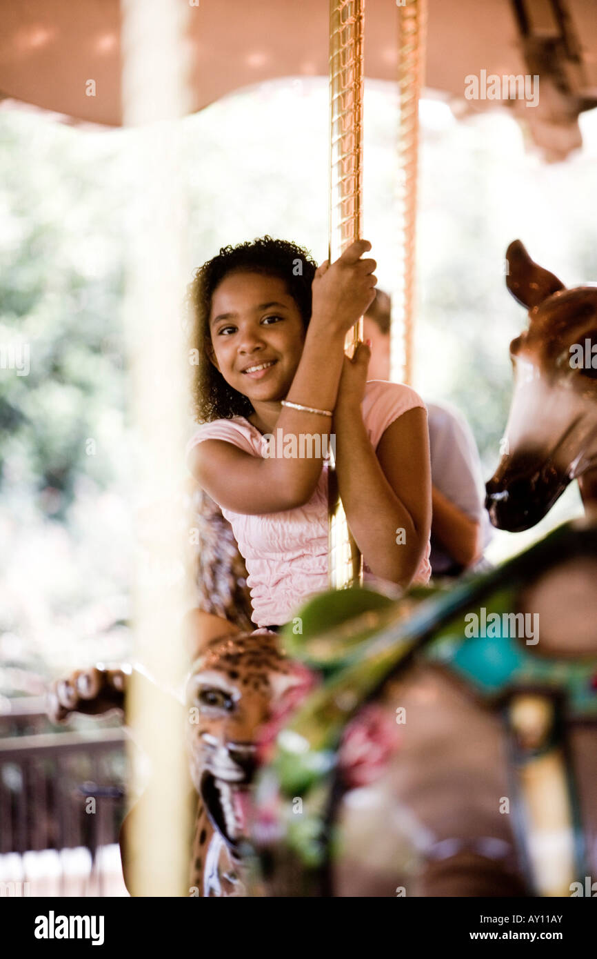 Portrait of a cheerful teenage girl sitting on a carousel Stock Photo ...