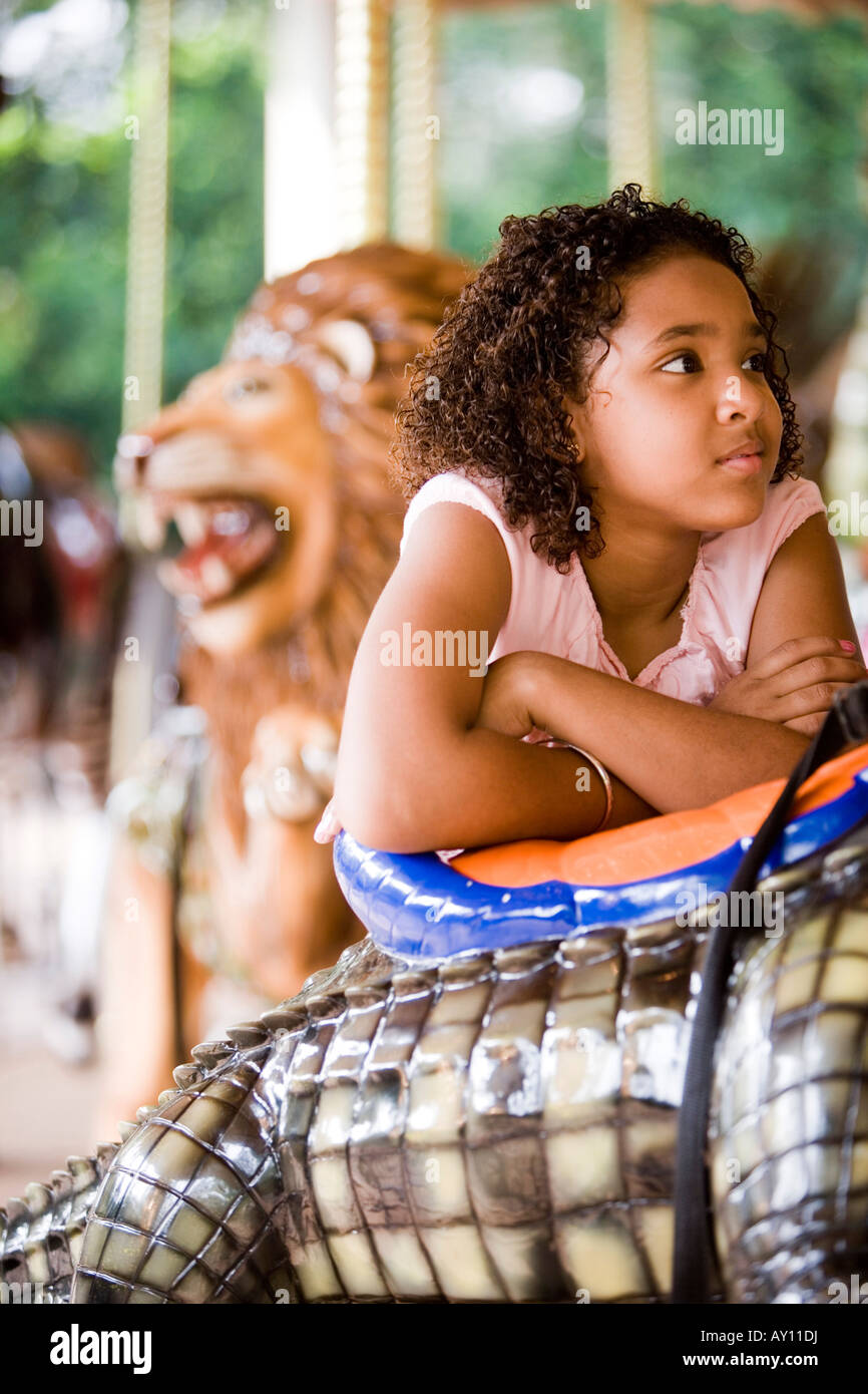 Teenage girl standing in a carousel with her arms crossed Stock Photo ...