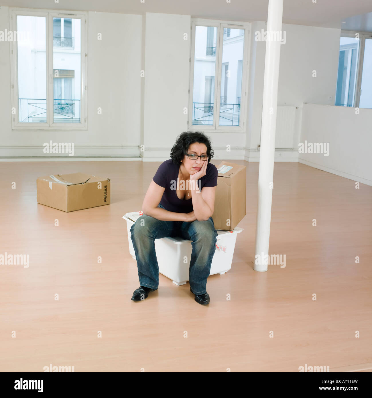 man sitting on the floor inside an empty loft appartement Stock Photo ...