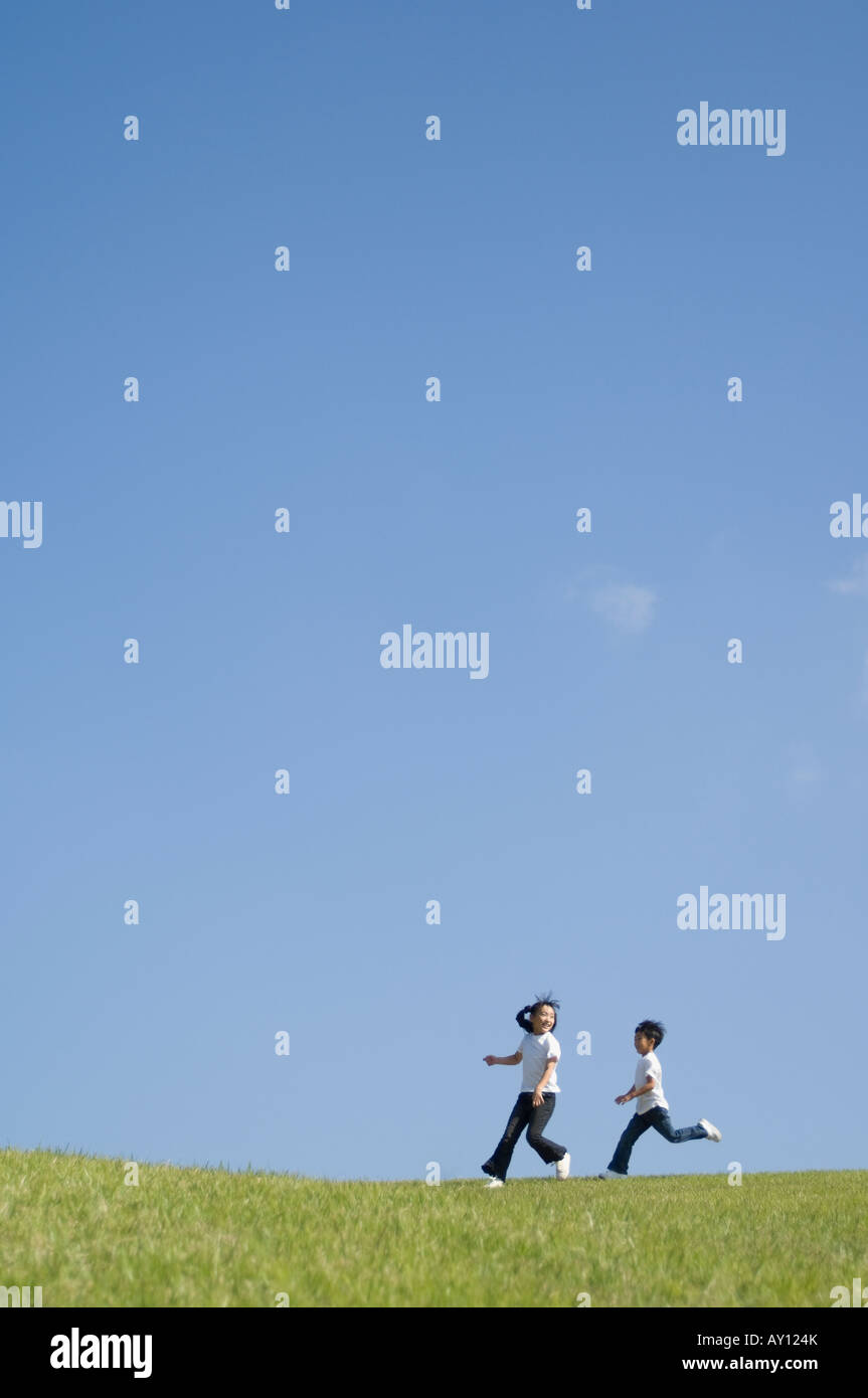 Children running in field Stock Photo - Alamy