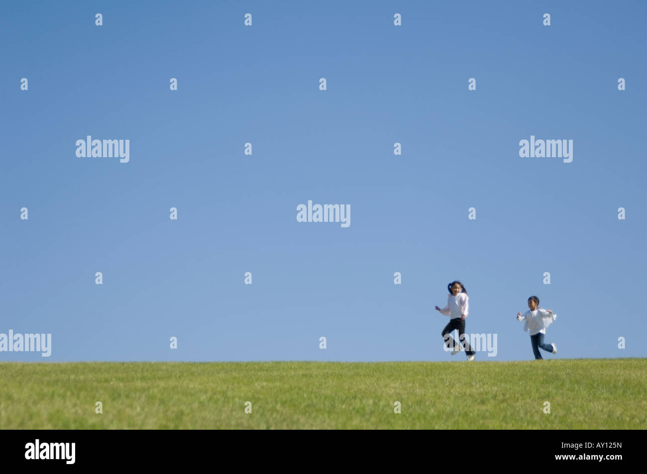 Children running in field Stock Photo - Alamy