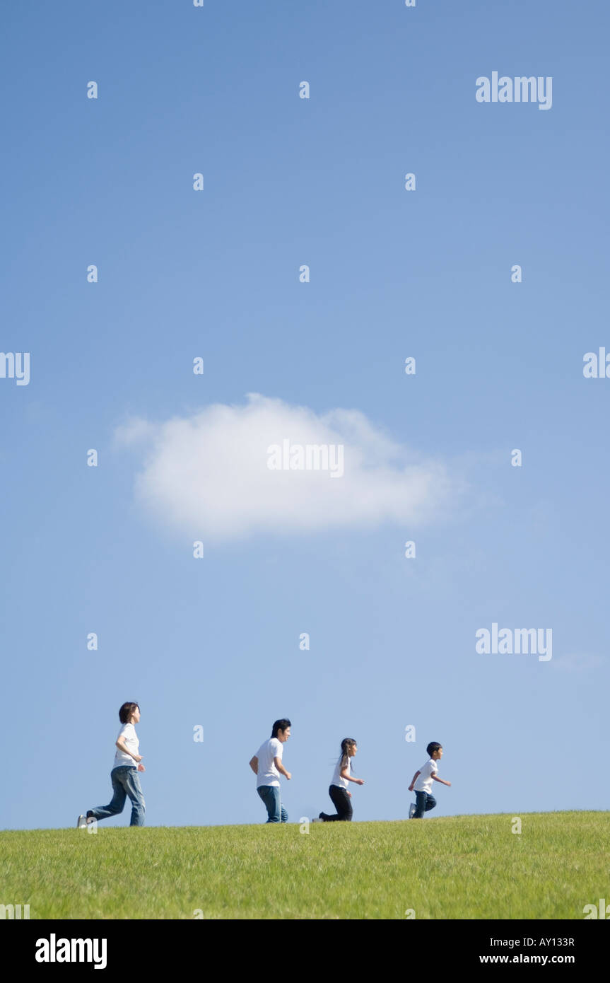 Family running in field Stock Photo - Alamy