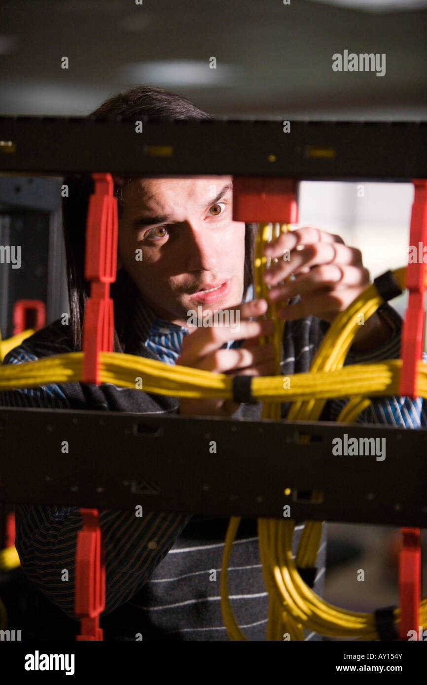 Young man connecting network connection plug Stock Photo - Alamy