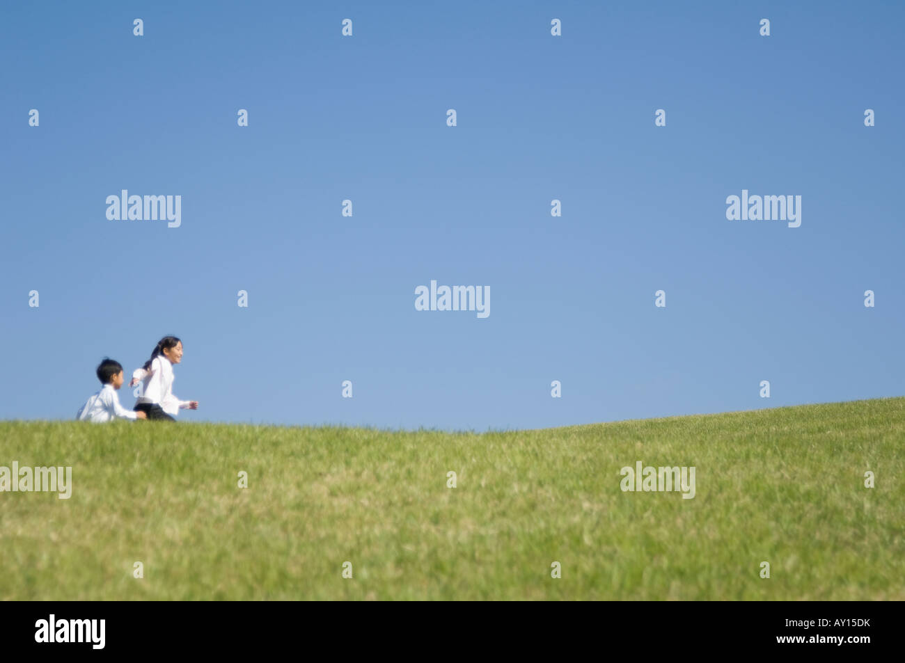 Children running in field Stock Photo - Alamy