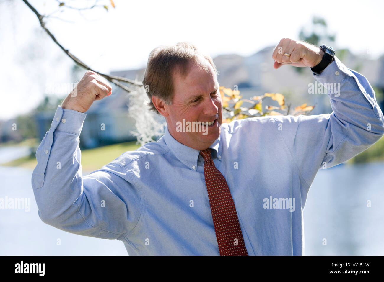 Business man flexing his muscles with the river in the background Stock ...