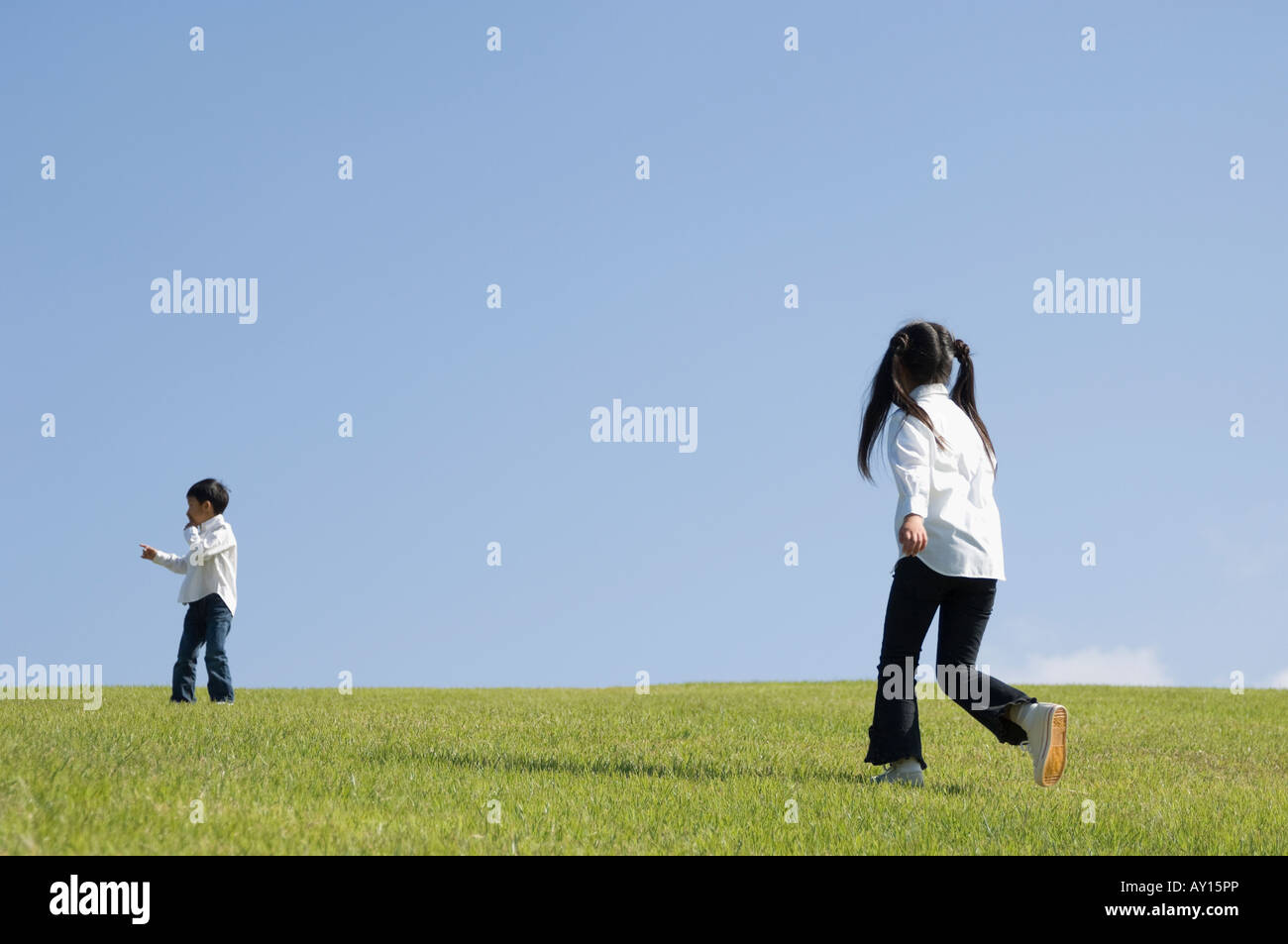 Children playing in field Stock Photo - Alamy