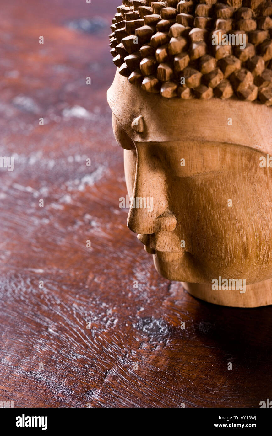 Close-up of a Buddha statue kept on the table Stock Photo - Alamy