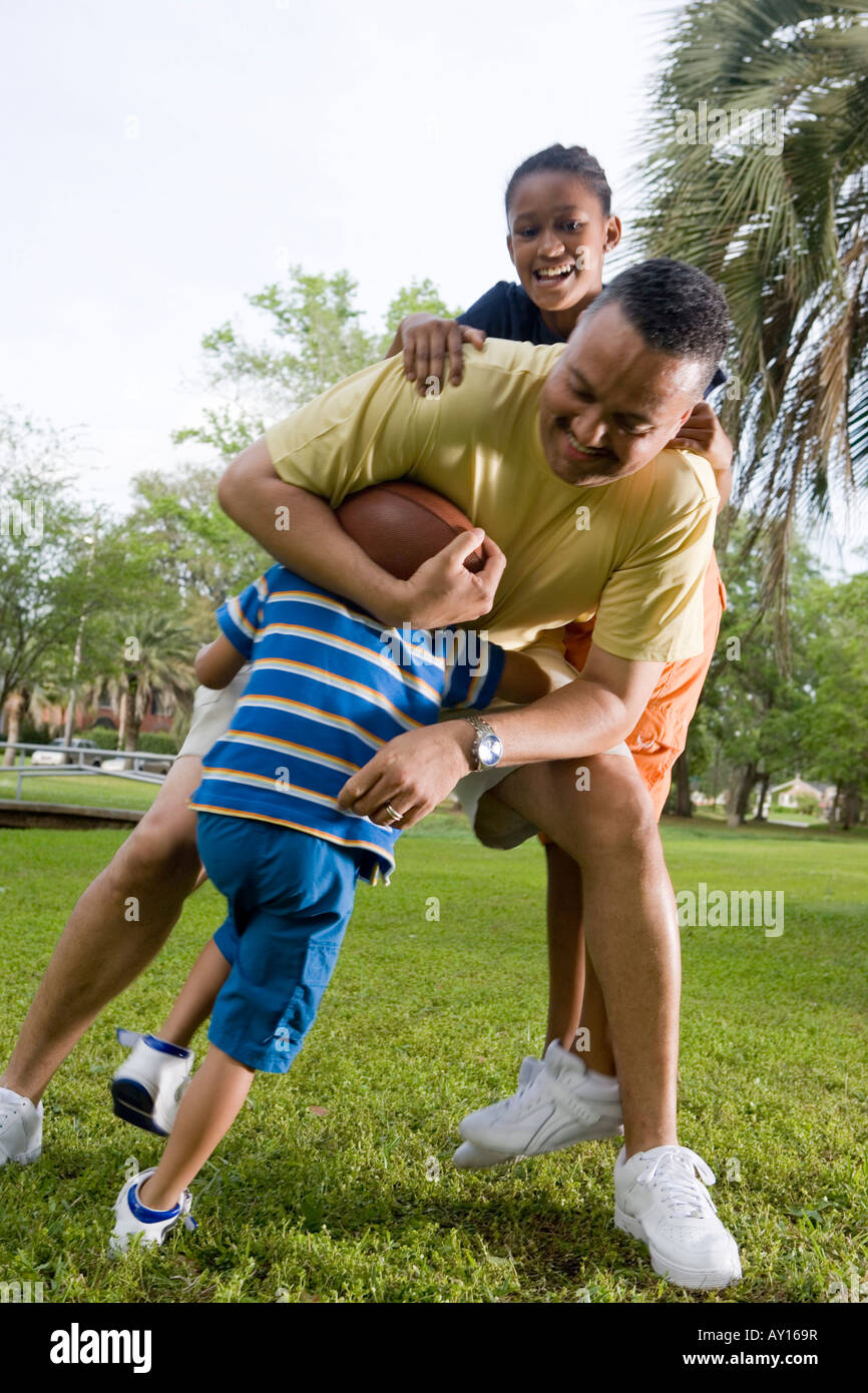 Father playing with their children at park Stock Photo - Alamy