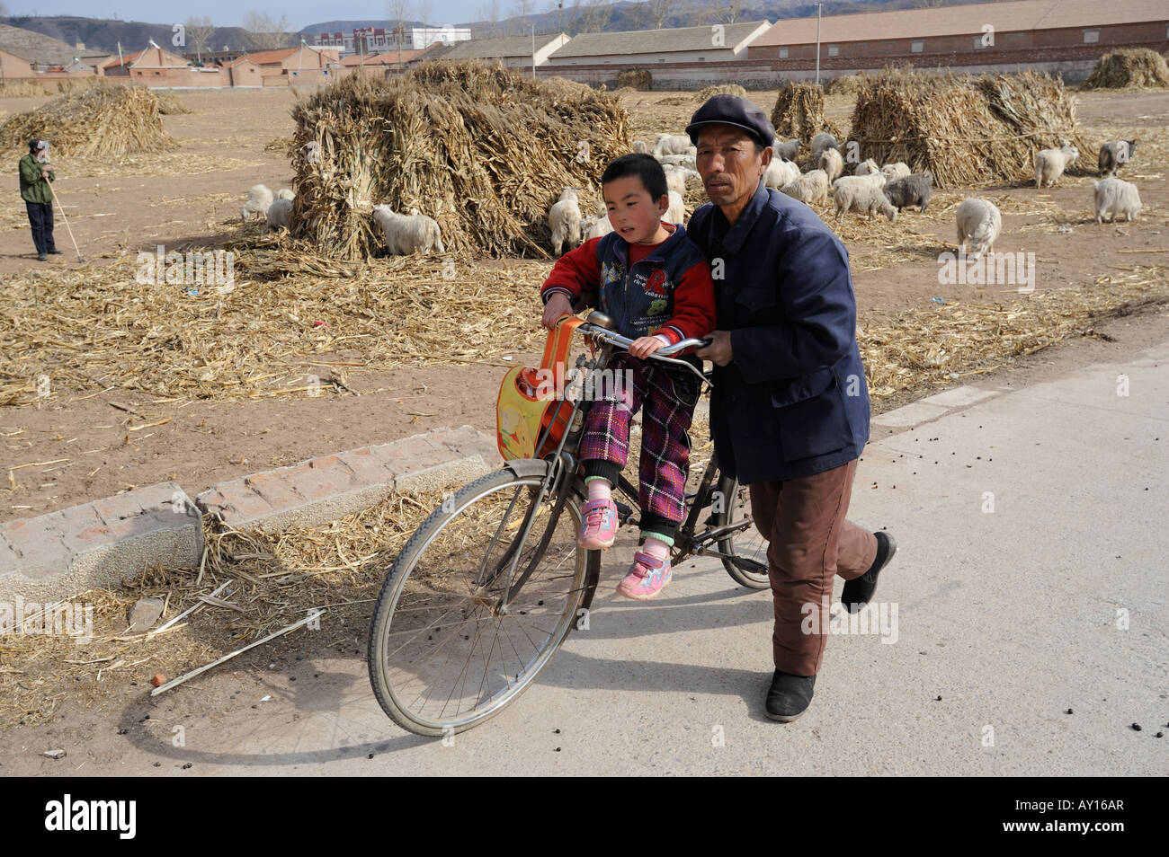 Old man carrying child bicycle hi-res stock photography and images - Alamy