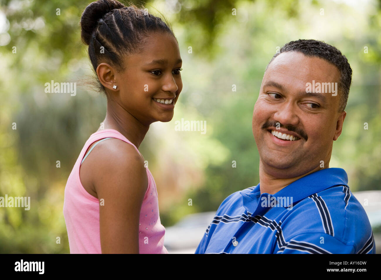 Father smiling with his daughter and looking away Stock Photo - Alamy