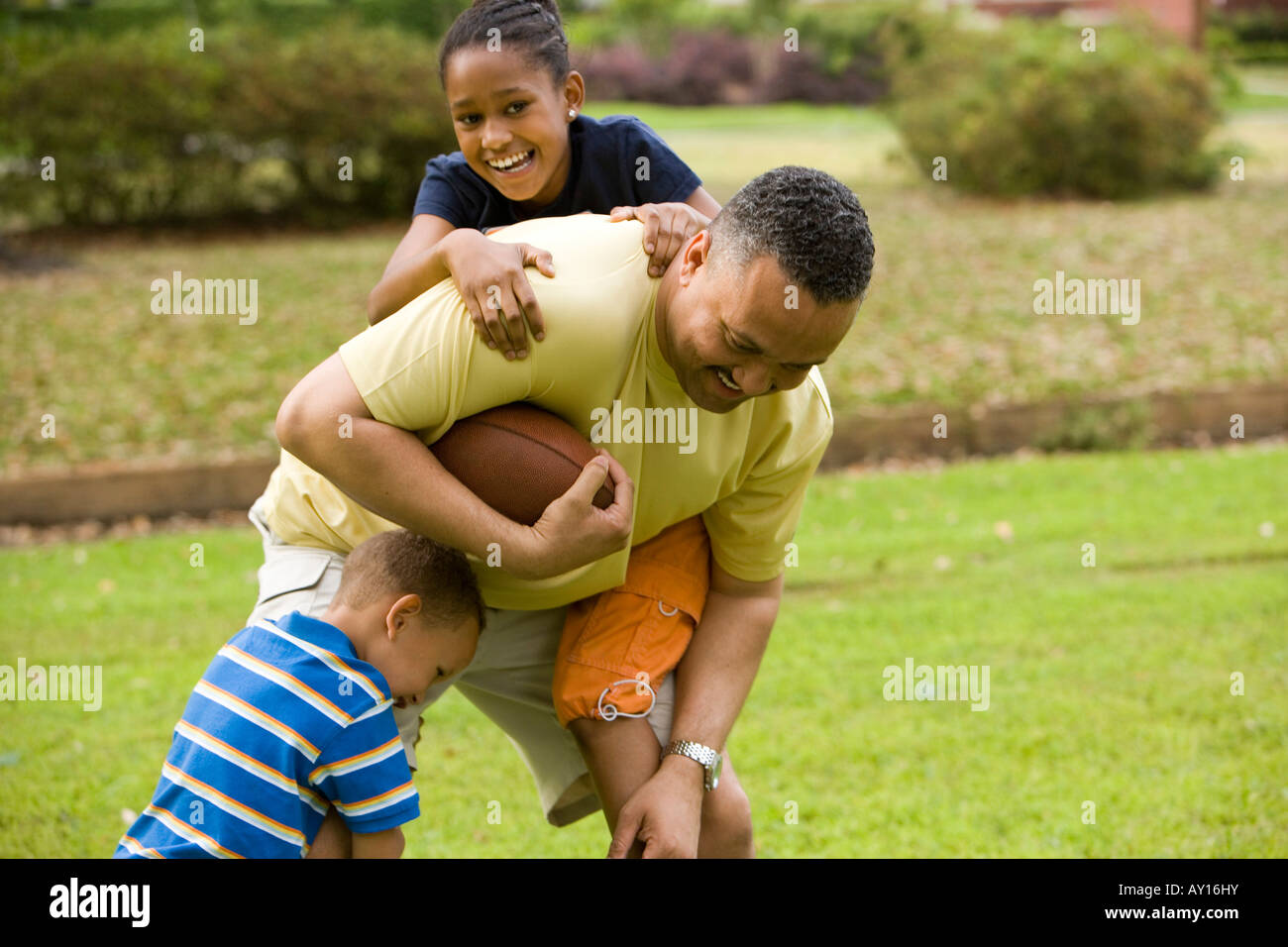 Father playing with their children at park Stock Photo - Alamy