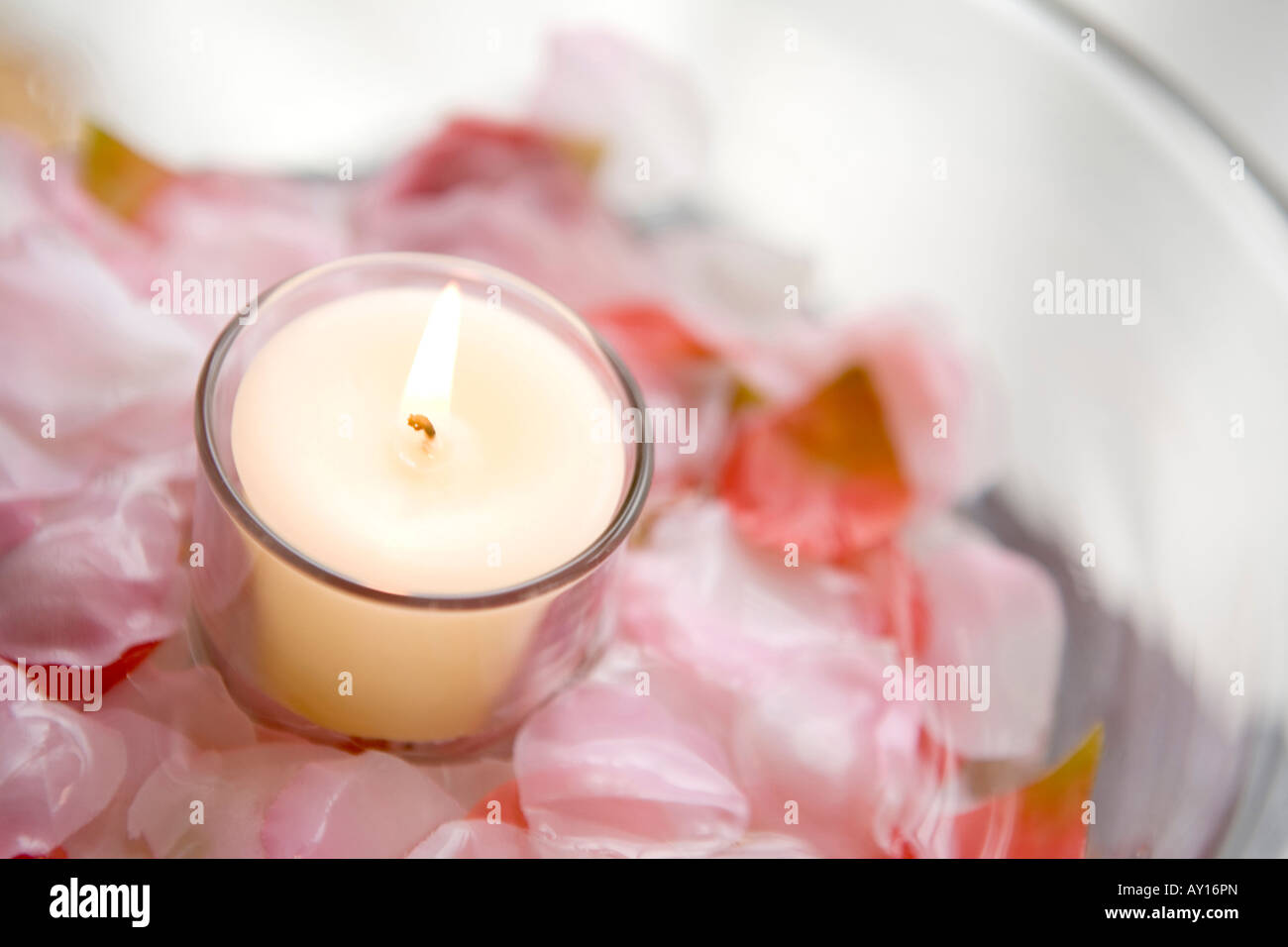 Candle floating in the water of a bowl Stock Photo - Alamy