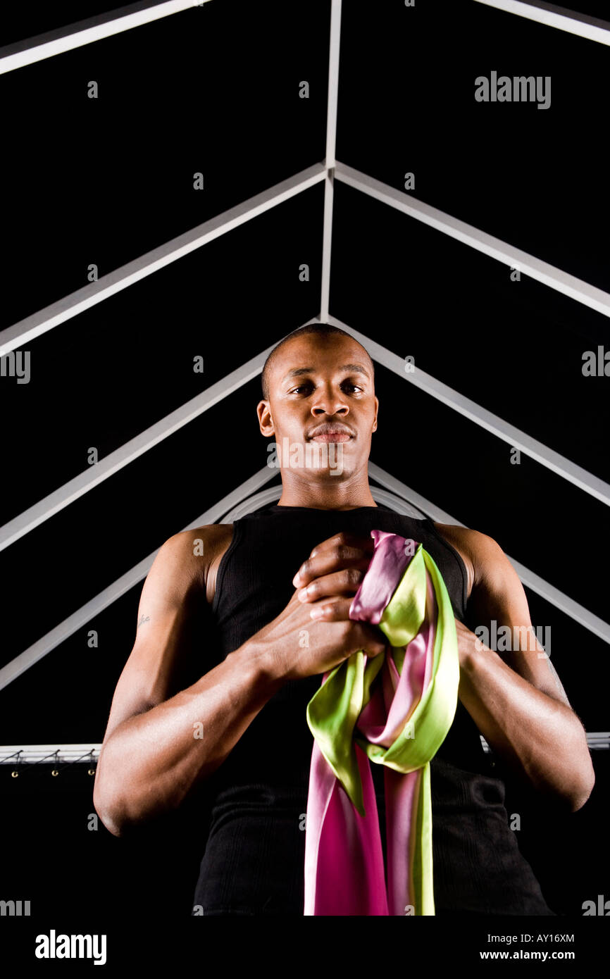 Portrait of a young man holding ribbons Stock Photo - Alamy