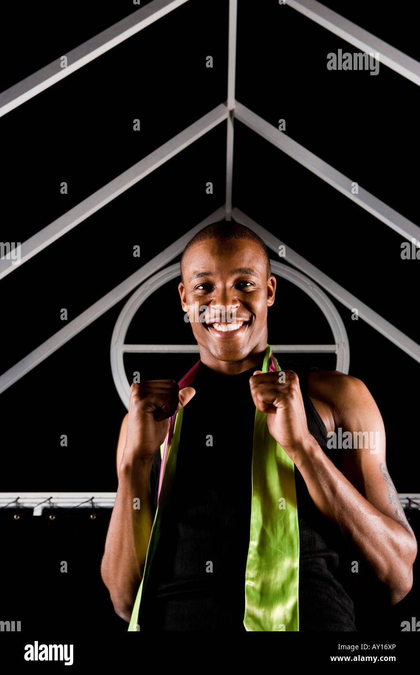 Portrait of a cheerful young man clenching fist Stock Photo - Alamy