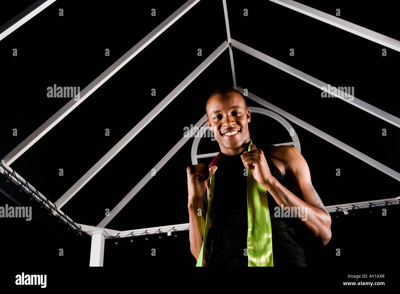 Portrait of a cheerful young man clenching fist Stock Photo - Alamy