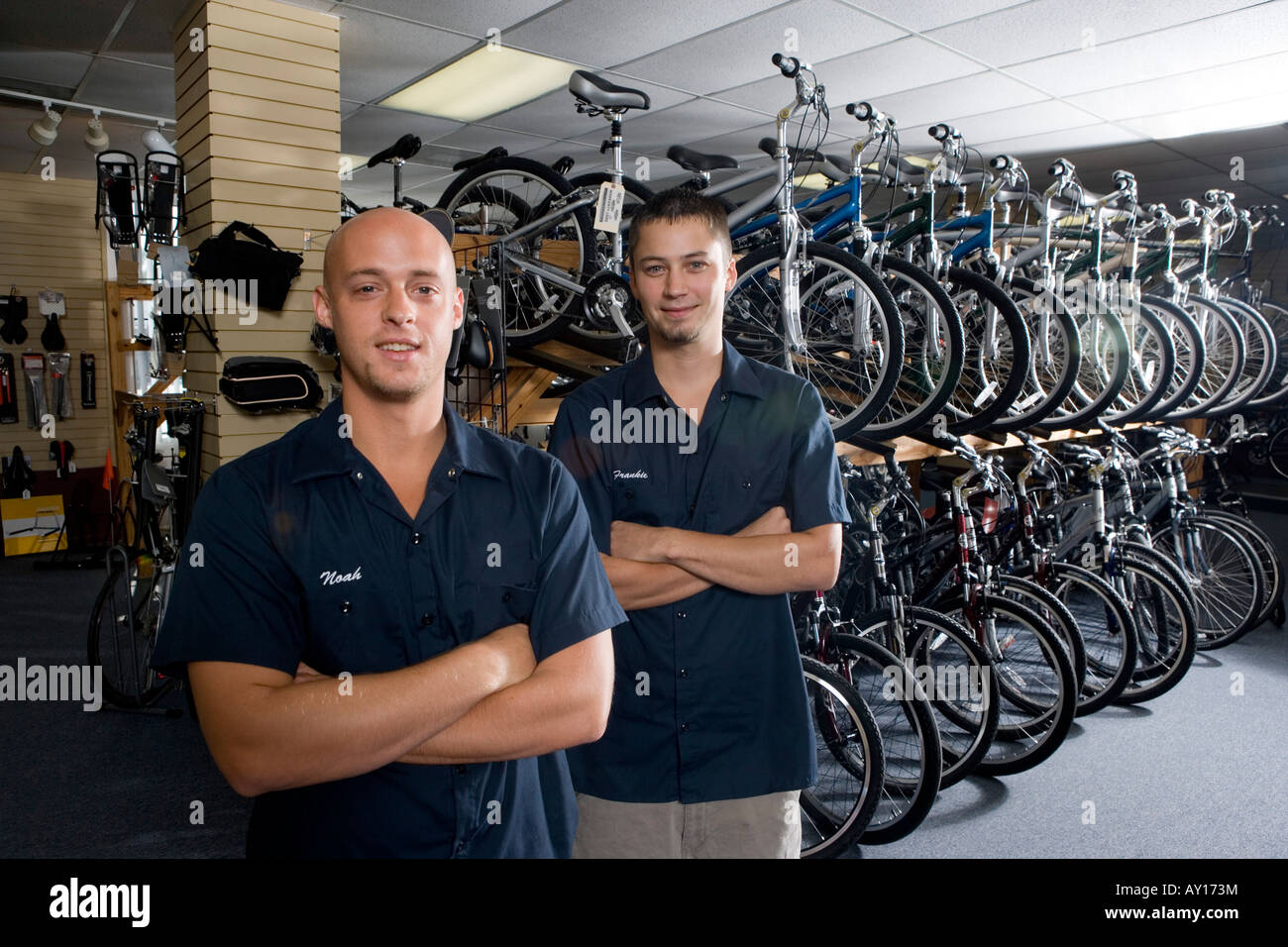 Portrait of smiling men in a bicycle shop Stock Photo - Alamy