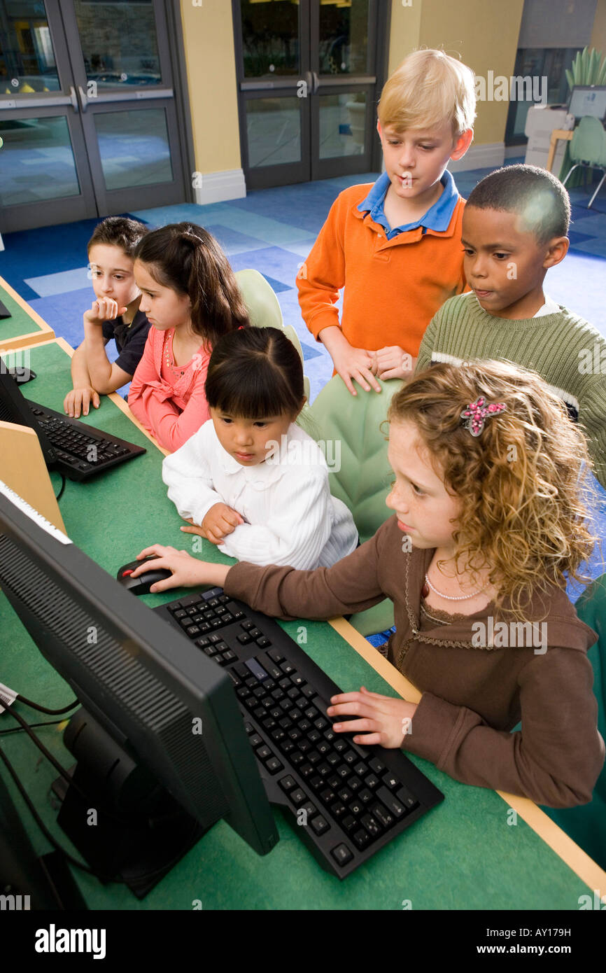 Schoolboys and girls using computer in the library Stock Photo - Alamy