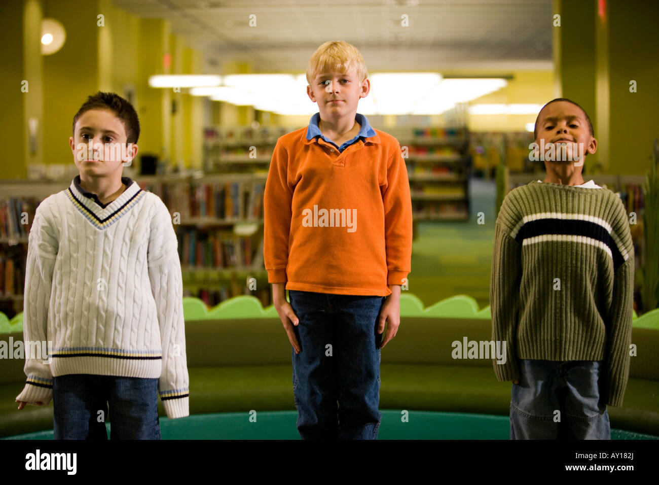 Portrait of schoolboys standing in a row in the library Stock Photo - Alamy