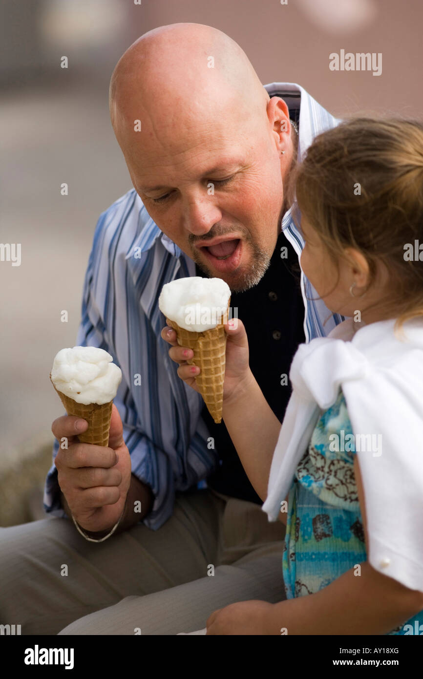 Father and daughter eating ice cream cones Stock Photo - Alamy