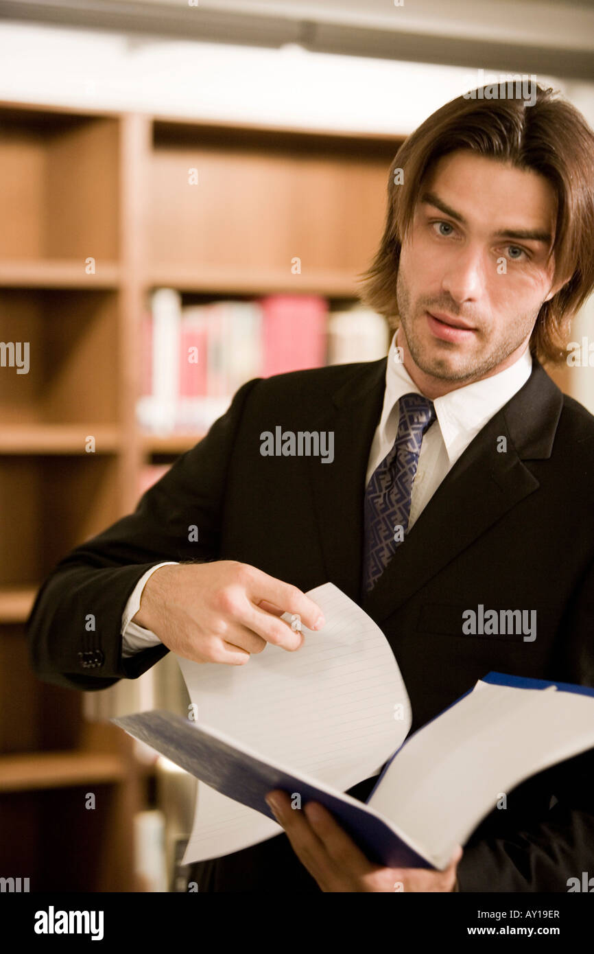Portrait of a businessman holding a file in an office Stock Photo - Alamy