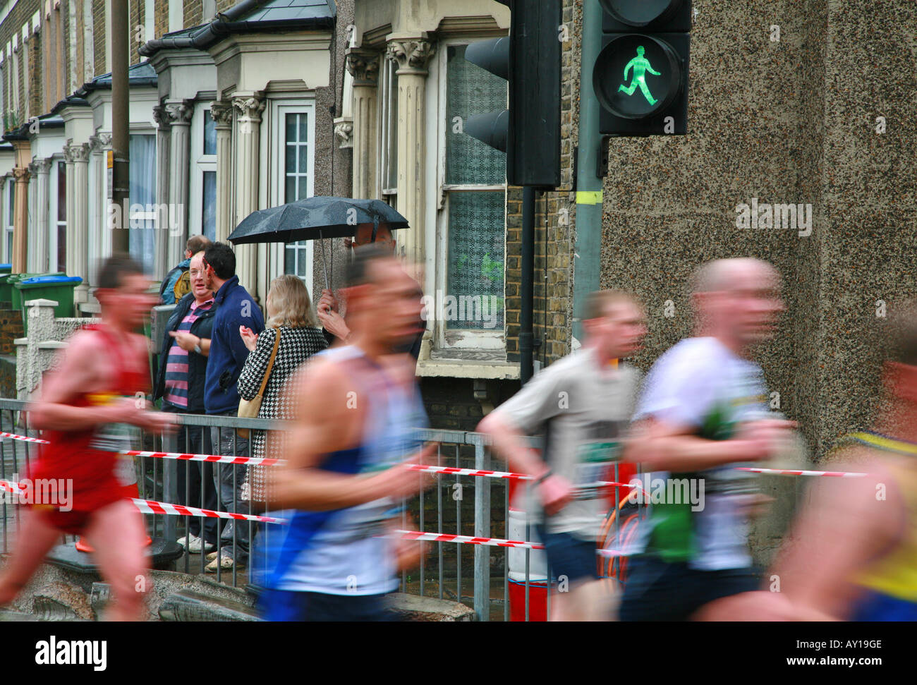 Green running man and London Marathoners Stock Photo - Alamy