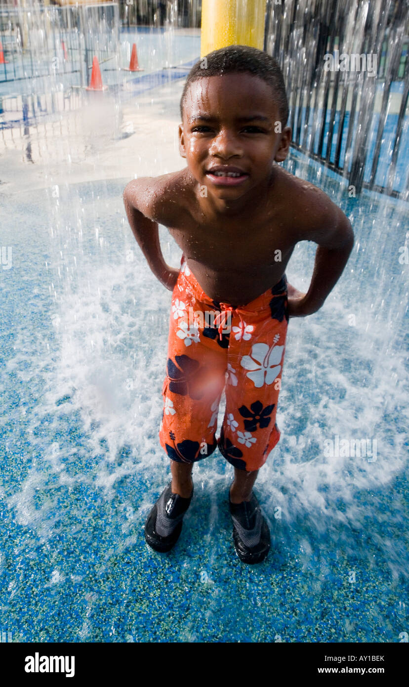 Portrait of a boy standing under a shower Stock Photo - Alamy