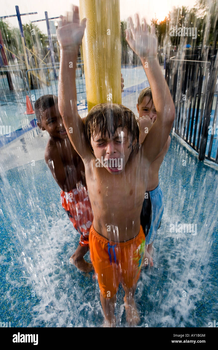 Boys standing under a shower Stock Photo - Alamy