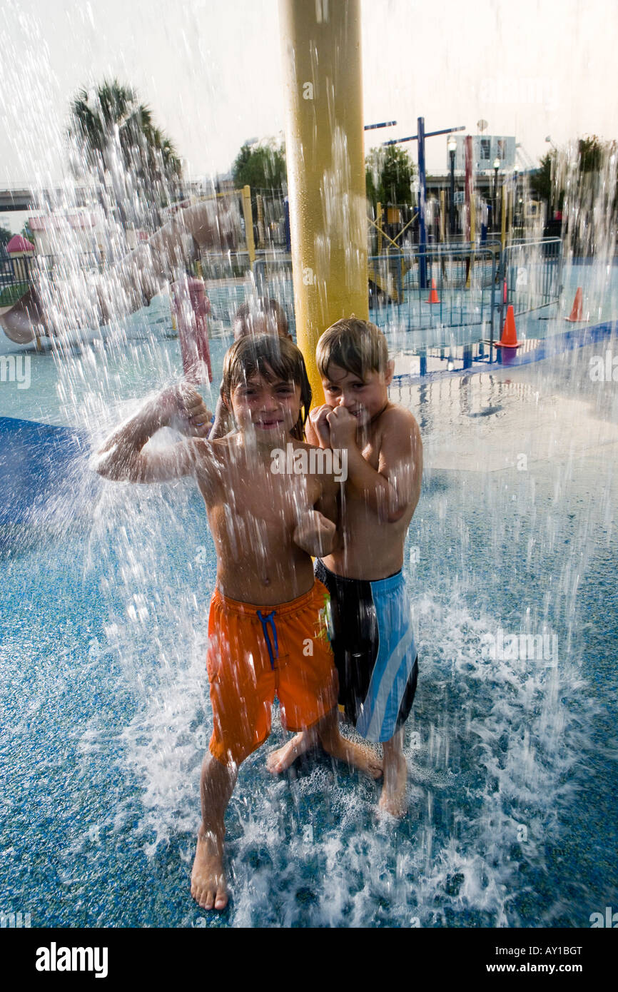 Portrait of boys standing under a shower Stock Photo - Alamy