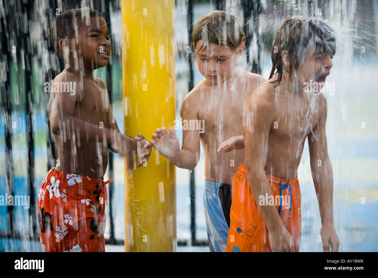 Boys standing together under a shower Stock Photo - Alamy