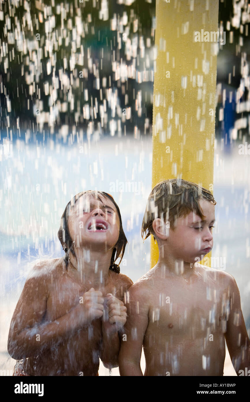 Boys standing together under a shower Stock Photo - Alamy